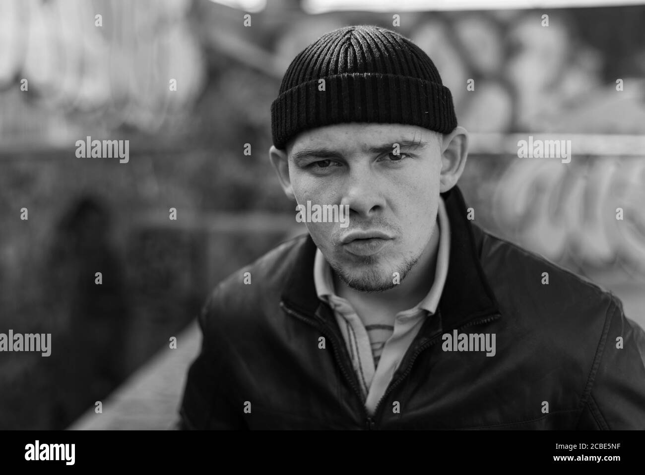Bully criminal in black leather jacket. Black and white photo Stock ...