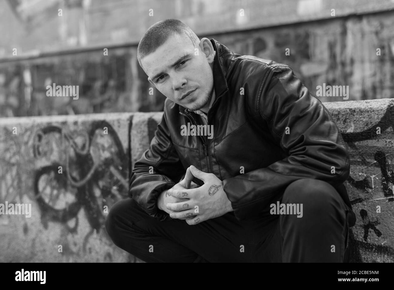 Bully criminal in black leather jacket. Black and white photo Stock ...