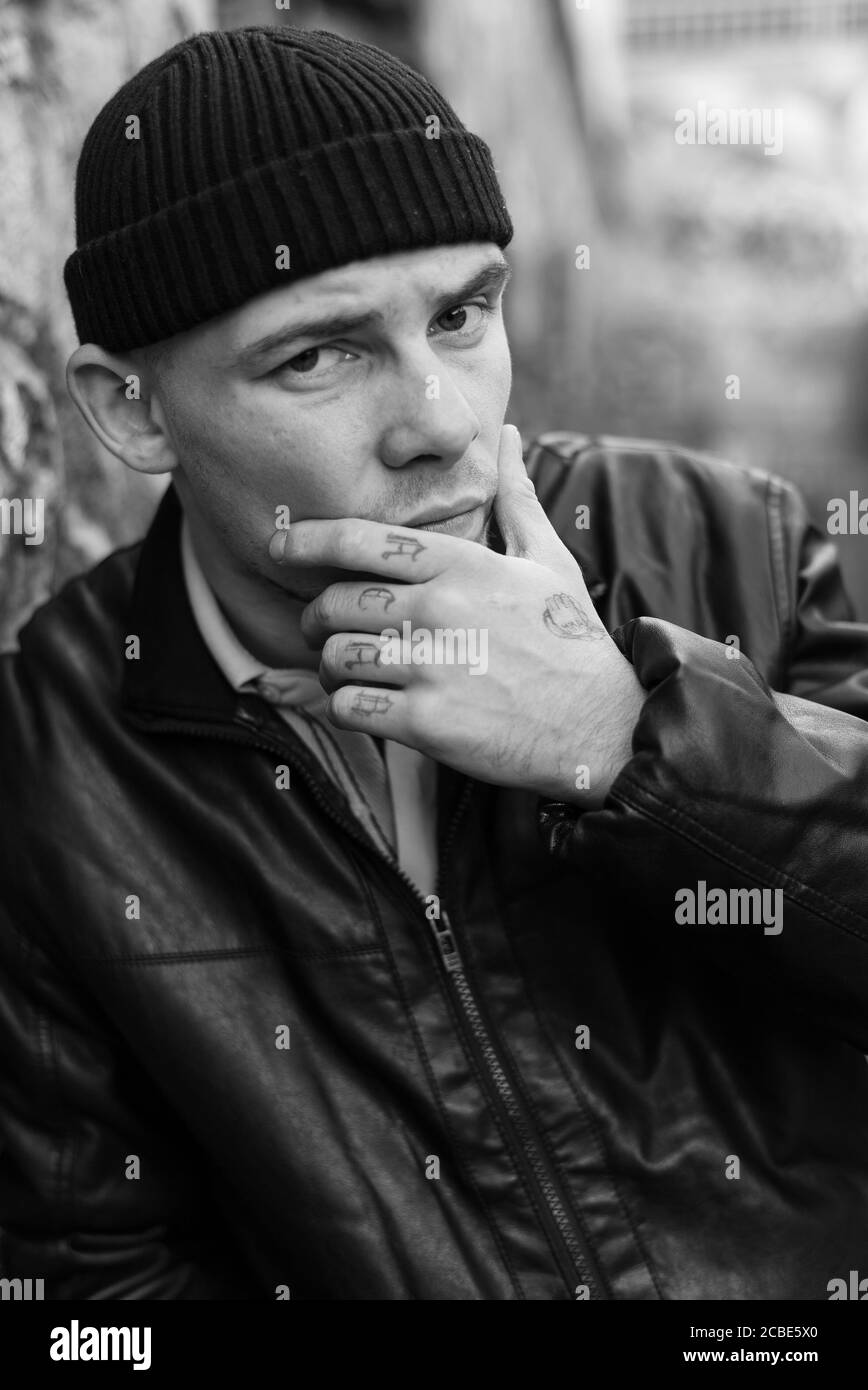 Bully criminal in black leather jacket. Black and white photo Stock ...