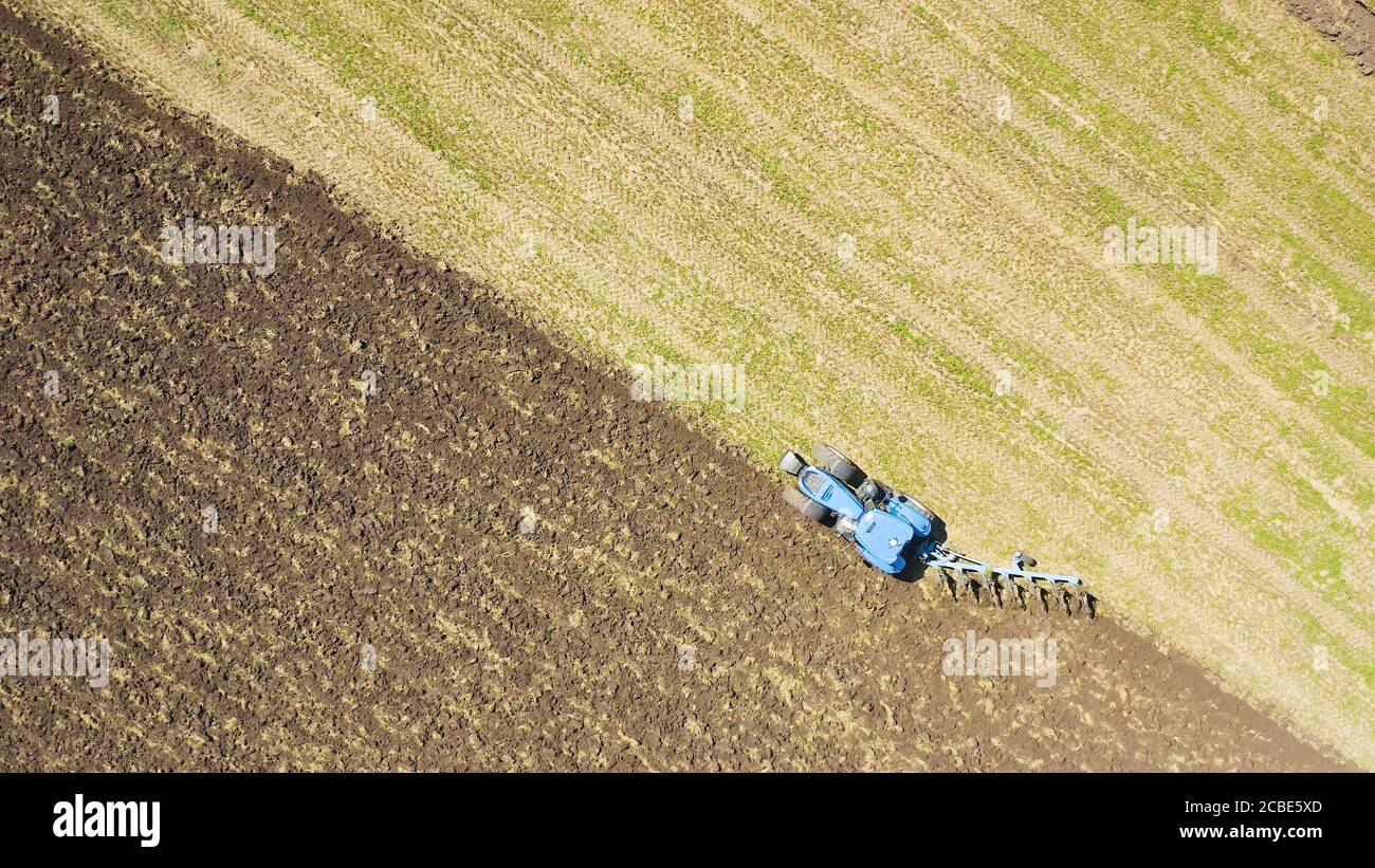 Aerial top view of a tractor on an industrial field Stock Photo - Alamy