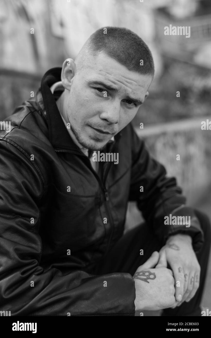 Bully criminal in black leather jacket. Black and white photo Stock ...