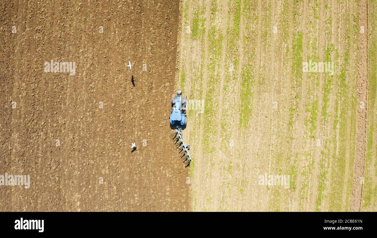 Aerial top view of a tractor on an industrial field Stock Photo - Alamy