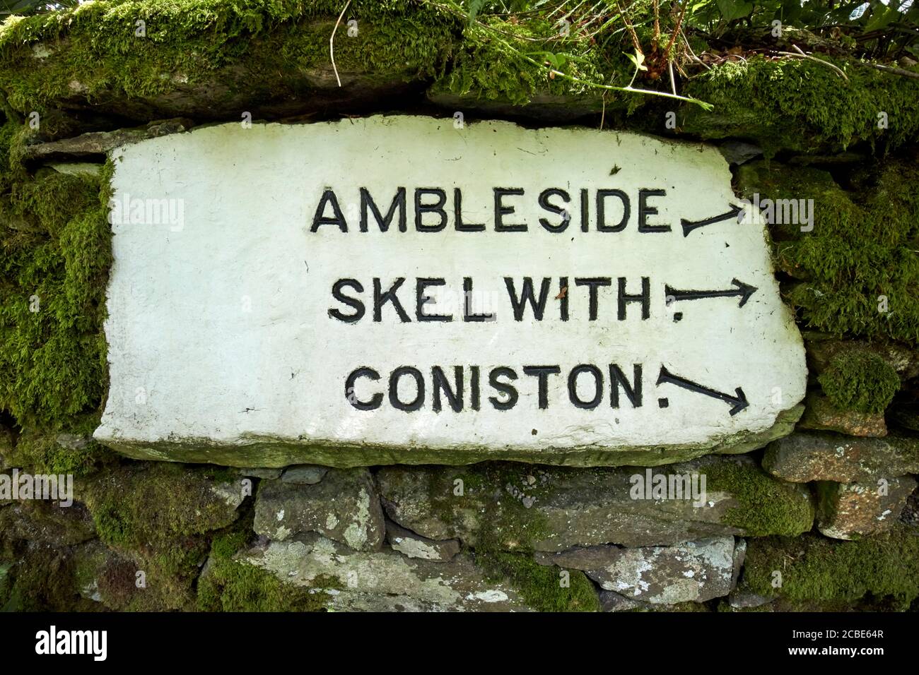 old sign carved into stone in stone wall for ambleside skelwith and ...