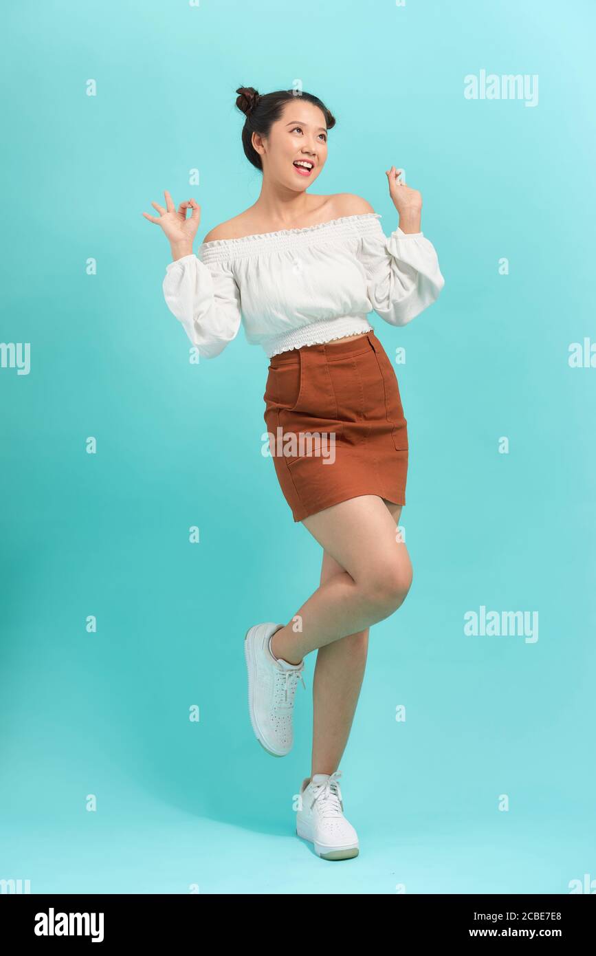 Full length photo of excited lovely woman screaming and raising hands ...