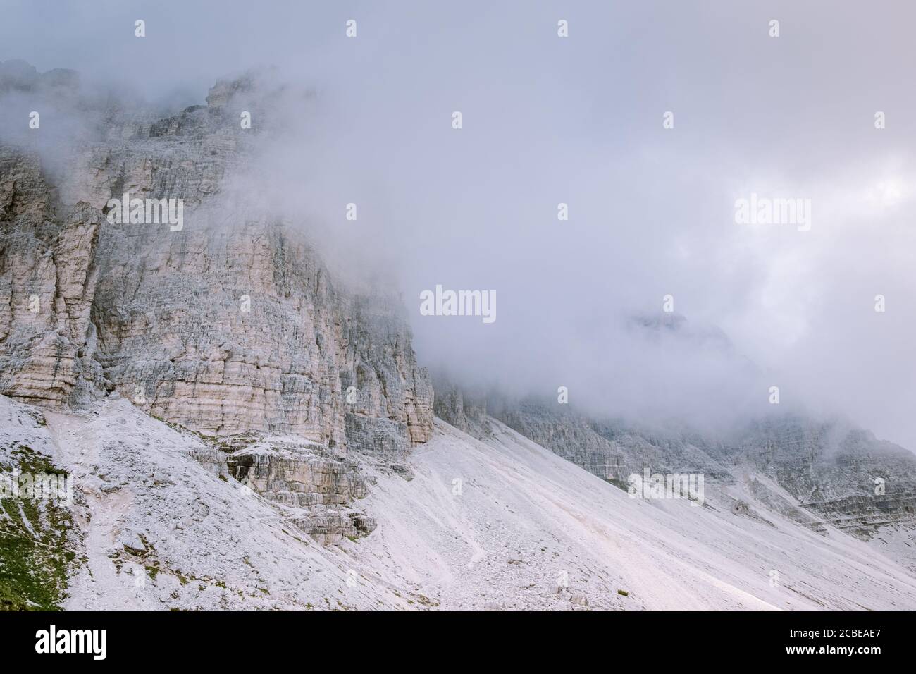 hiking in the italian dolomites during foggy weather with clouds ...