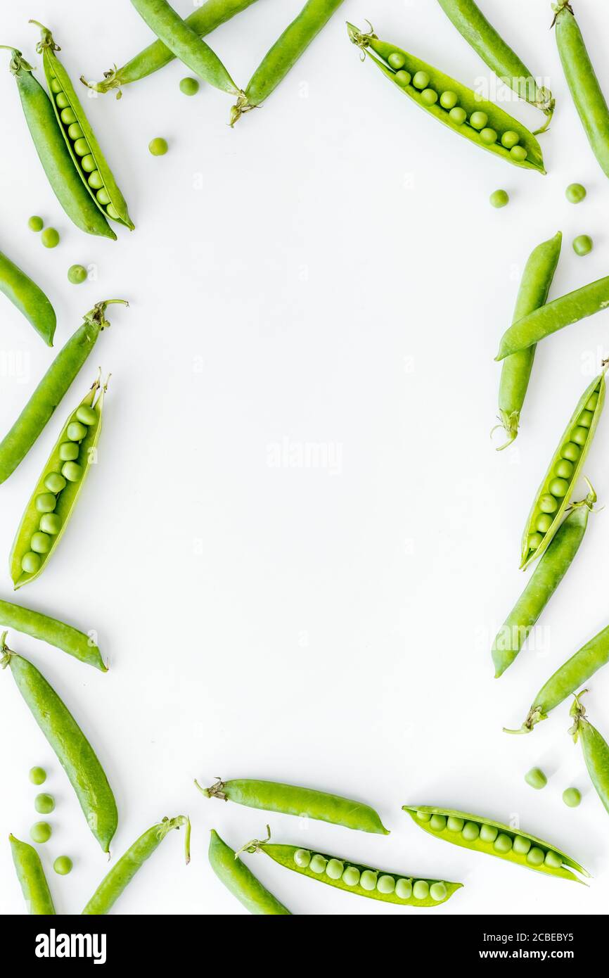 Frame of green pea pods and peas on the kitchen background Stock Photo ...
