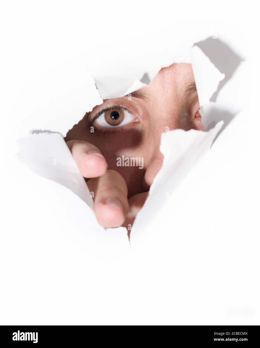 Vertical isolated closeup shot of a Hispanic male peeking through a ...