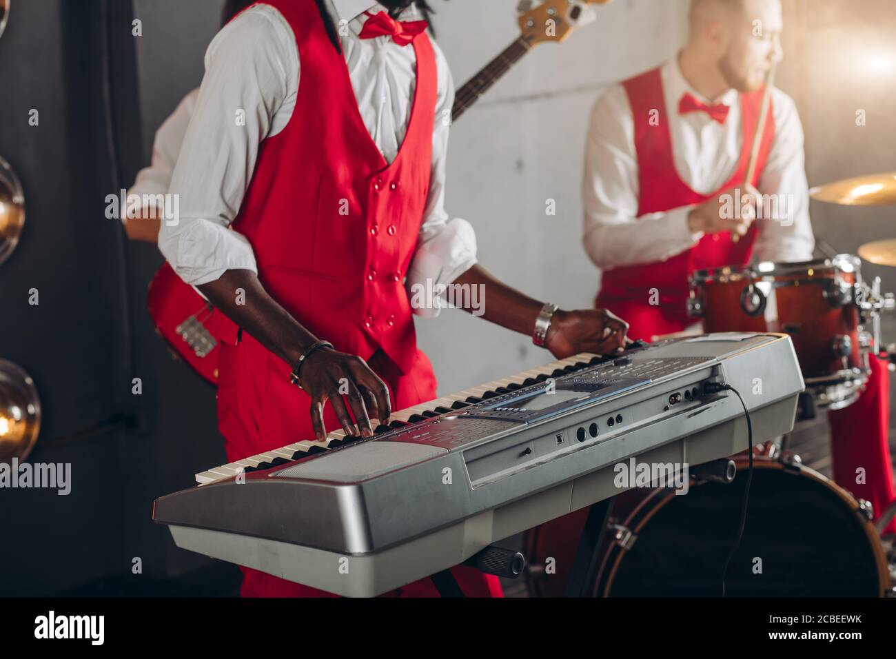 Professional music band singing a song in a studio. close up cropped ...