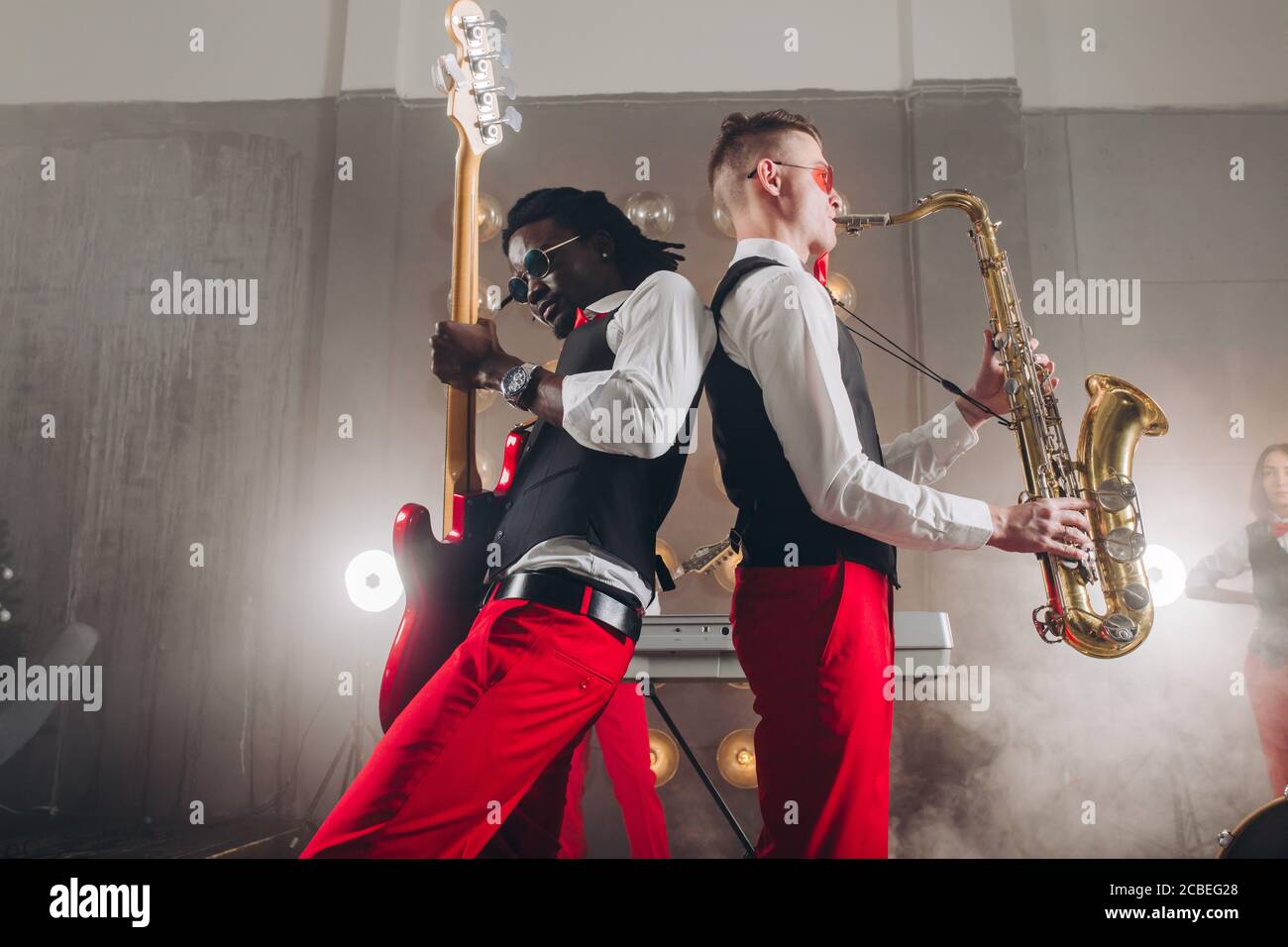 stylish two musicians are performing on the smoky stage. lifestyle ...