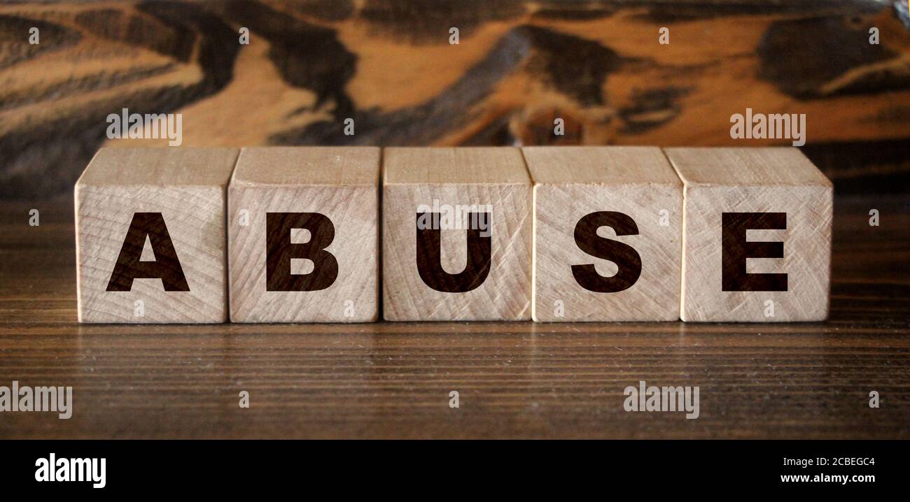 Wooden cubes with word ABUSE on wooden table. Addiction behavior ...