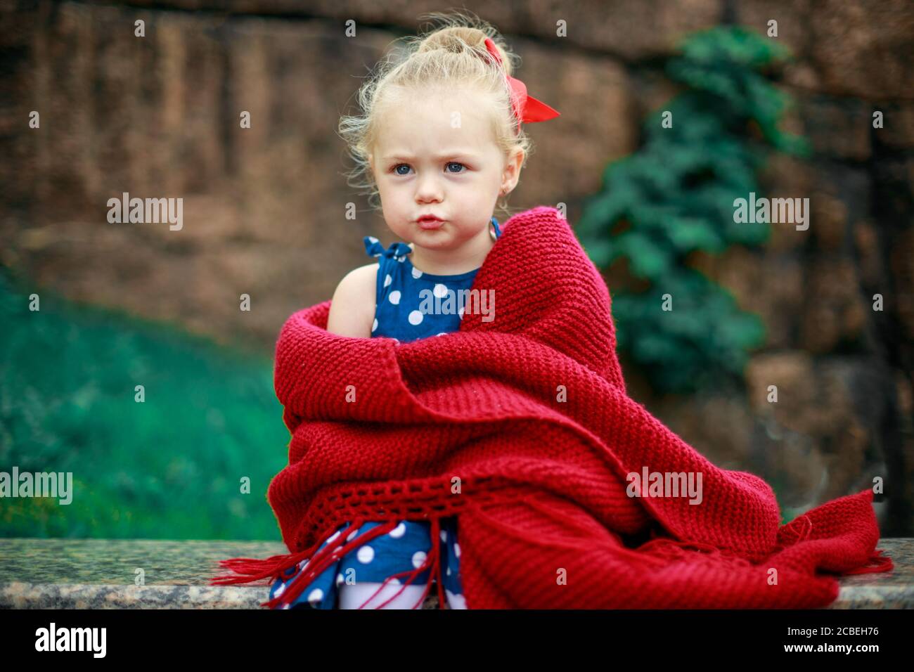 sad girl sitting wrapped in a blanket Stock Photo - Alamy