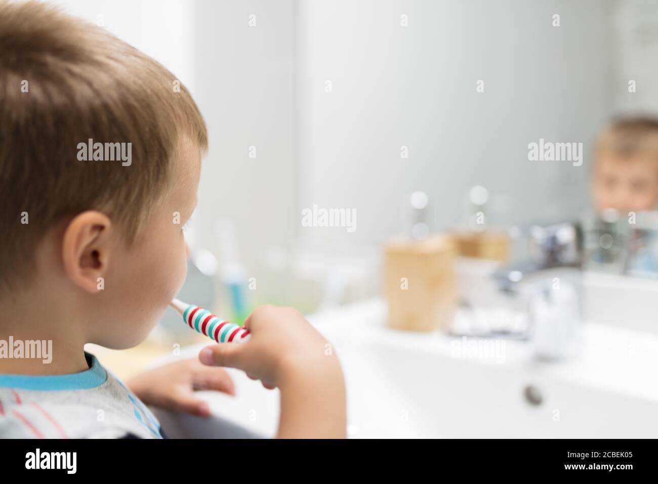 Adorable child brushing his teeth in the bathroom Stock Photo - Alamy