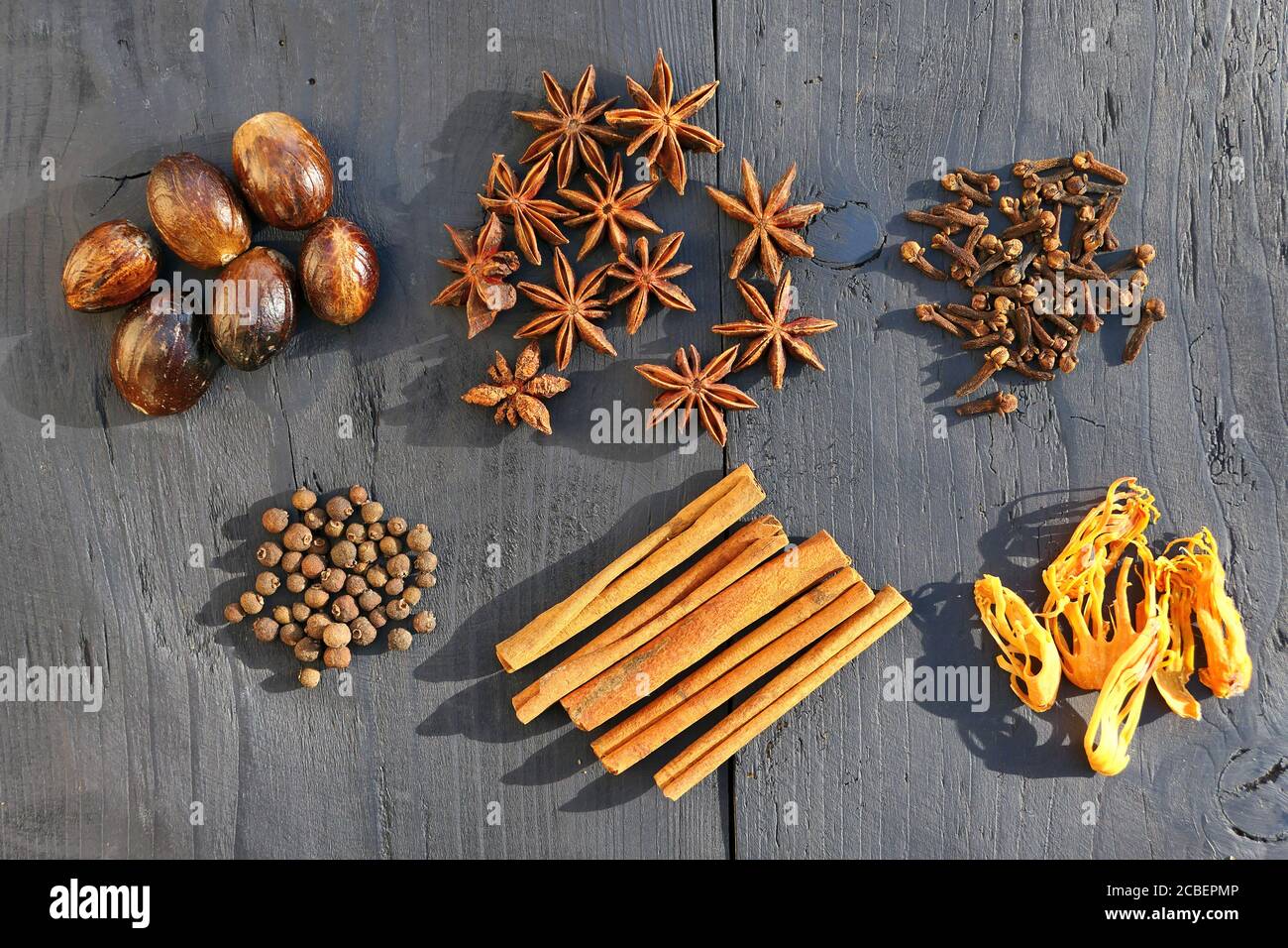 Collection of warming brown spices on wooden background. Vintage style ...
