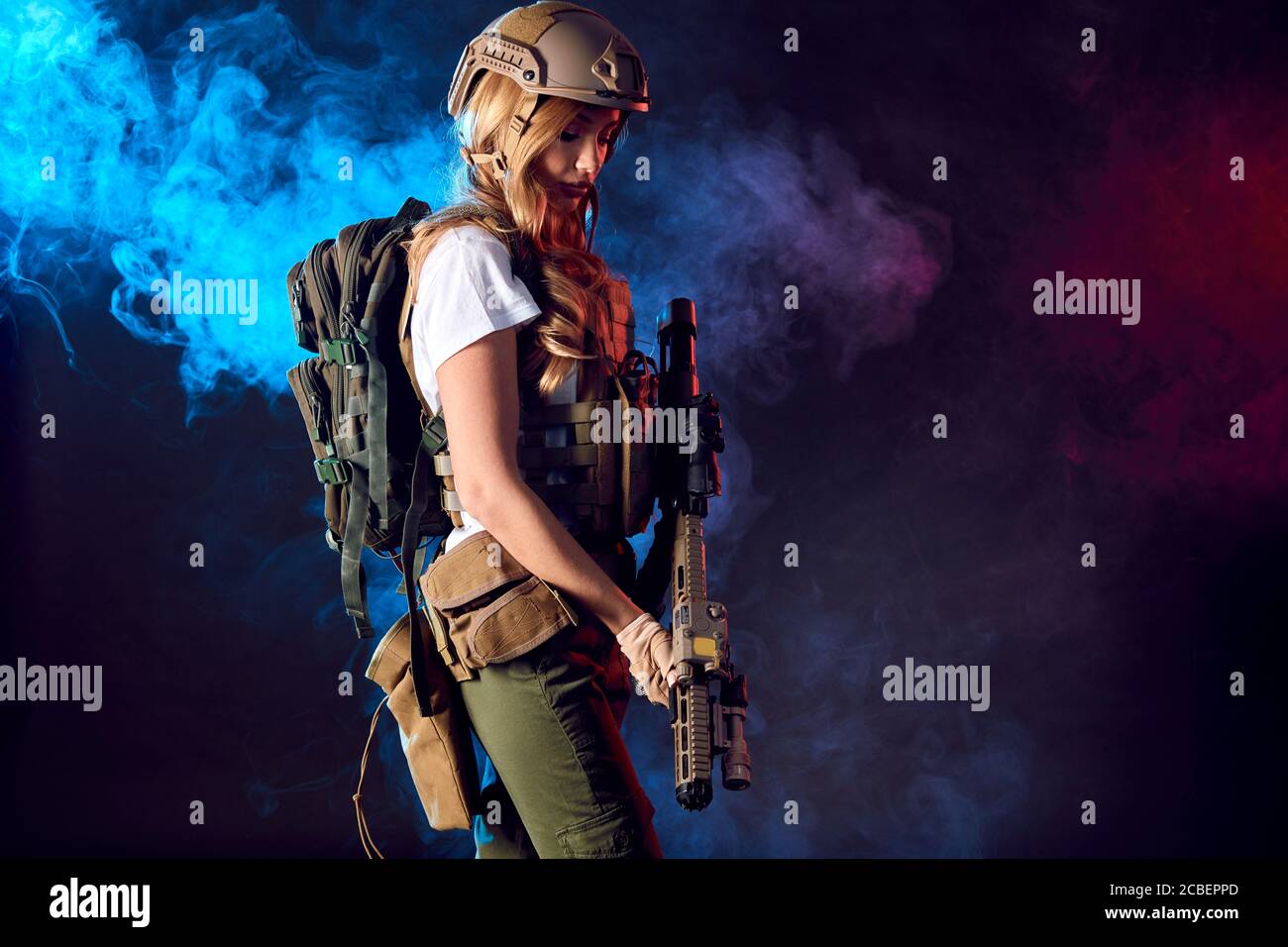 Female storm trooper in military camouflage uniform protected with ...