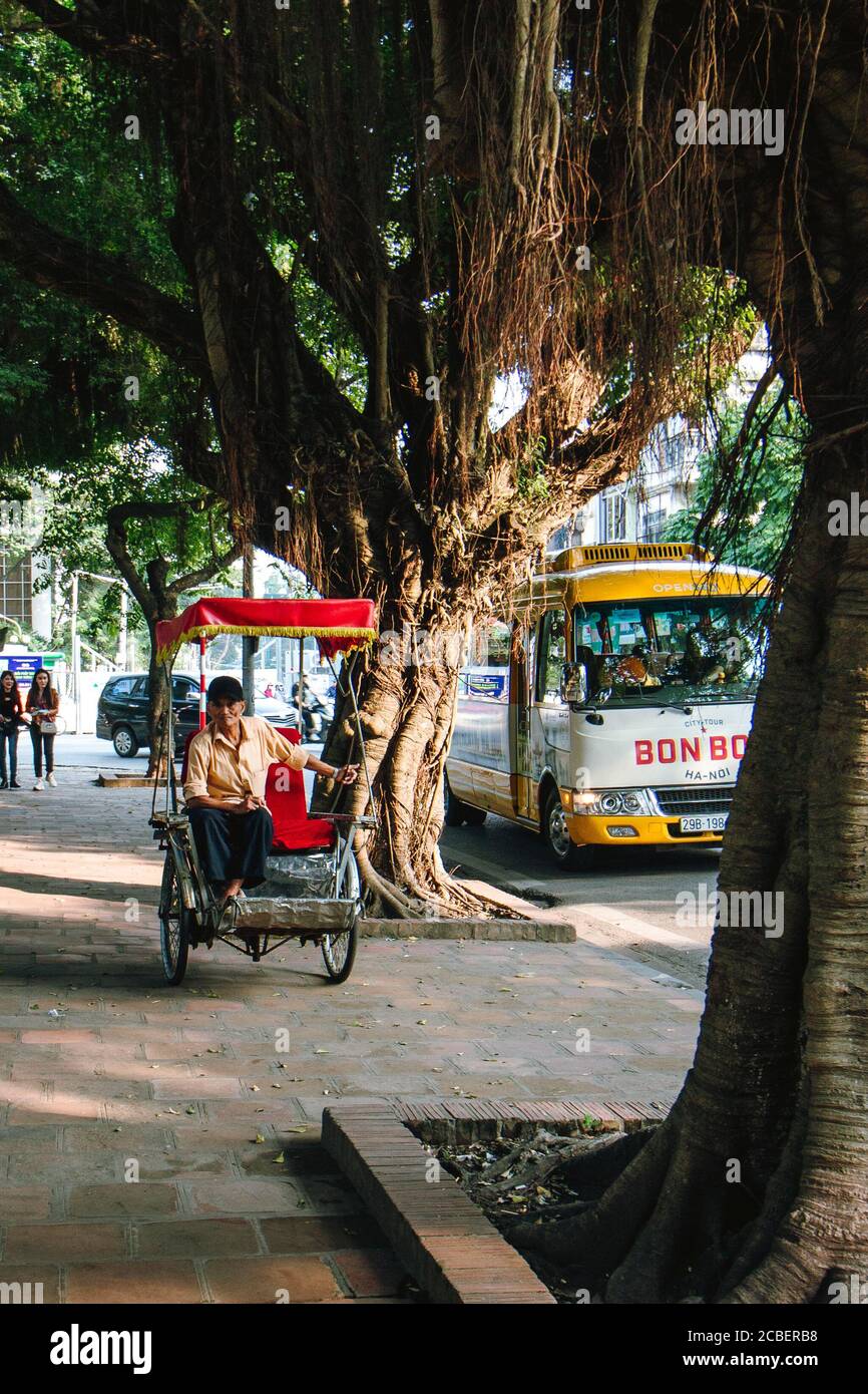 HANOI, VIETNAM - Nov 04, 2019: a waiting rickshaw driver in front of ...