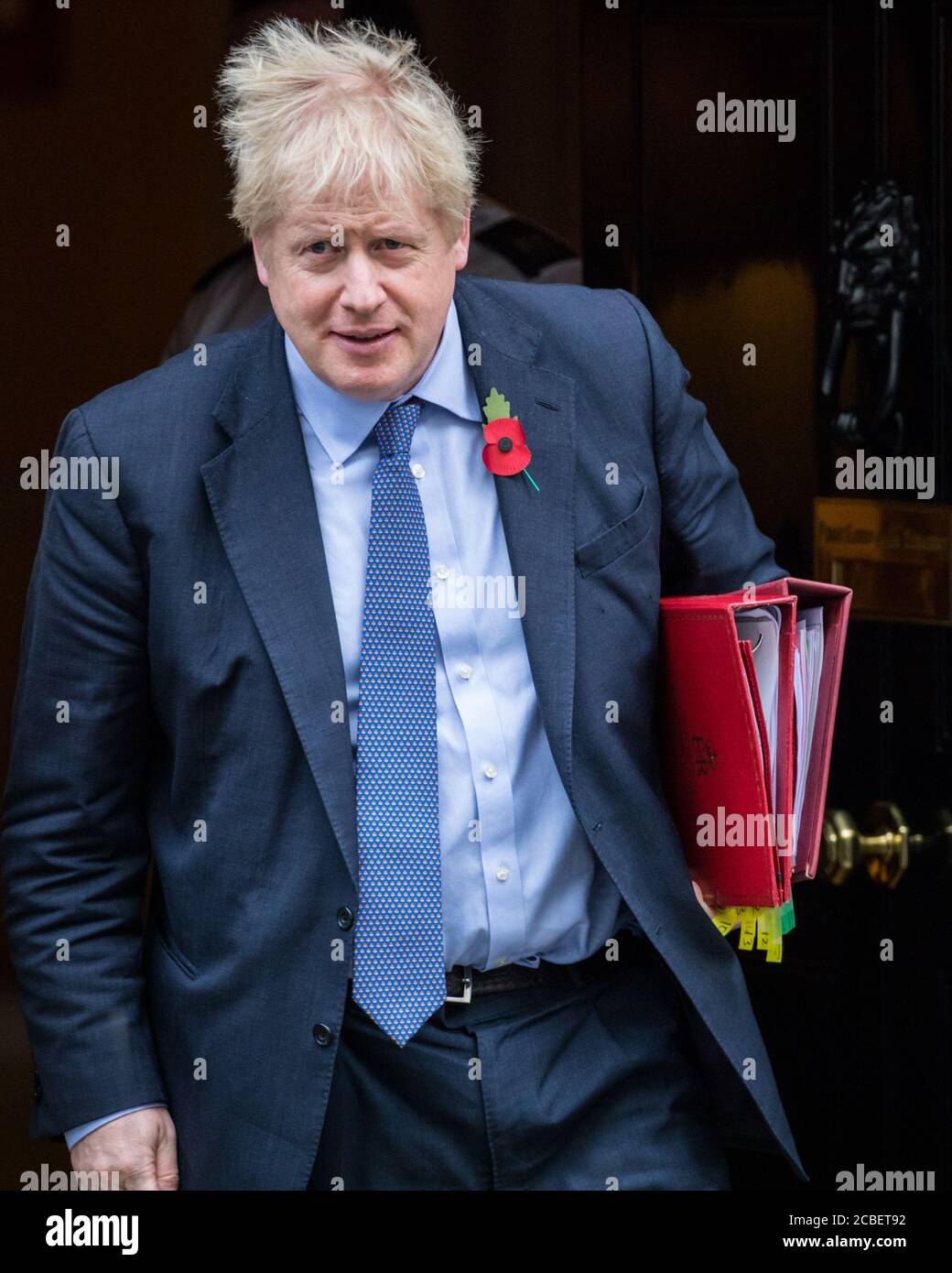 Prime Minister Boris Johnson leaves 10 Downing Street, looking at the ...