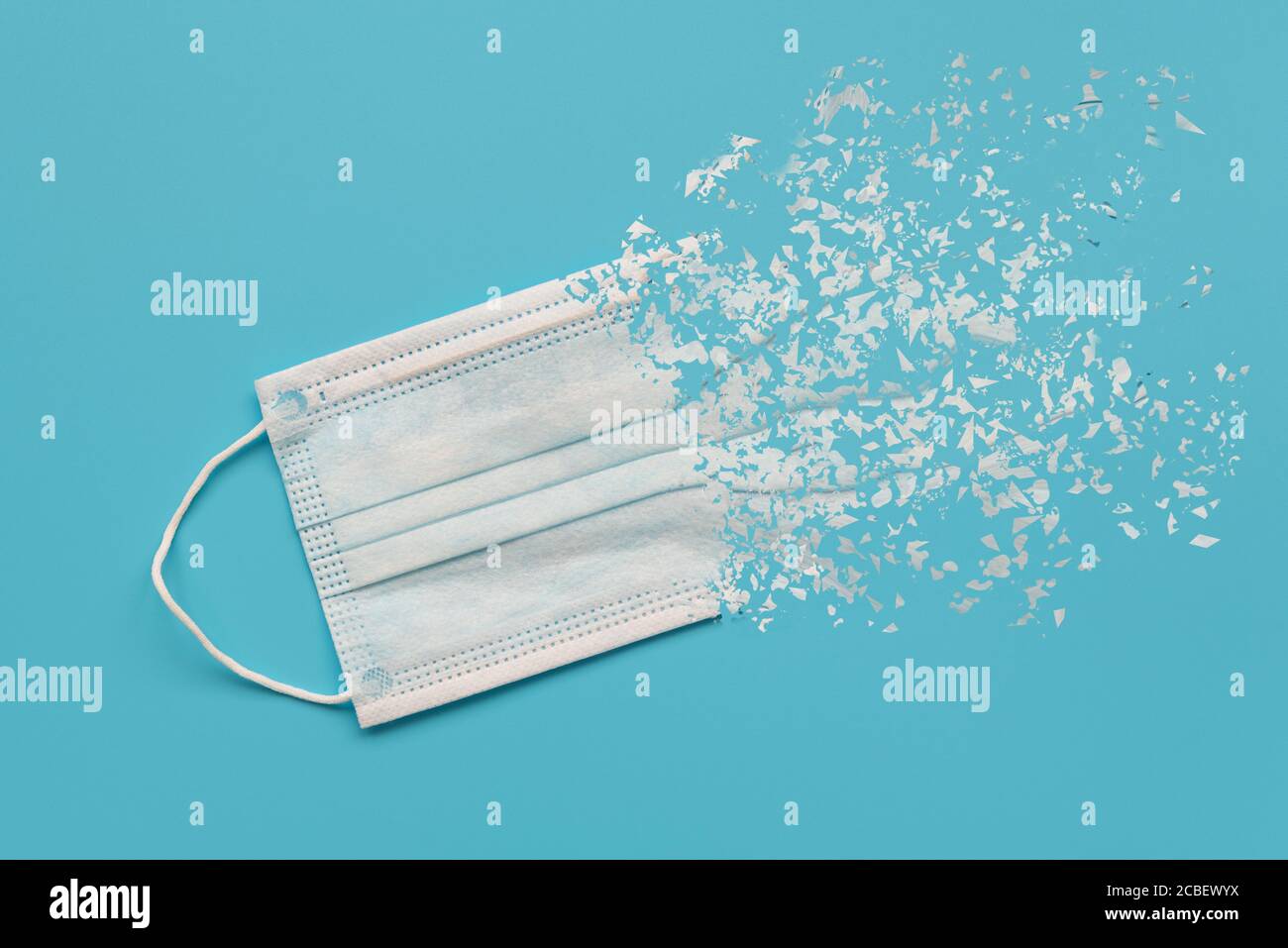 Protective mask with dispersion effect on blue background. Covid-19 ...