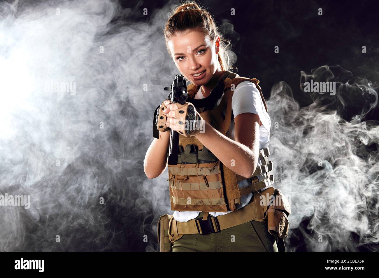 Airsoft female shooter playing strikeball, sets her sights on enemy ...