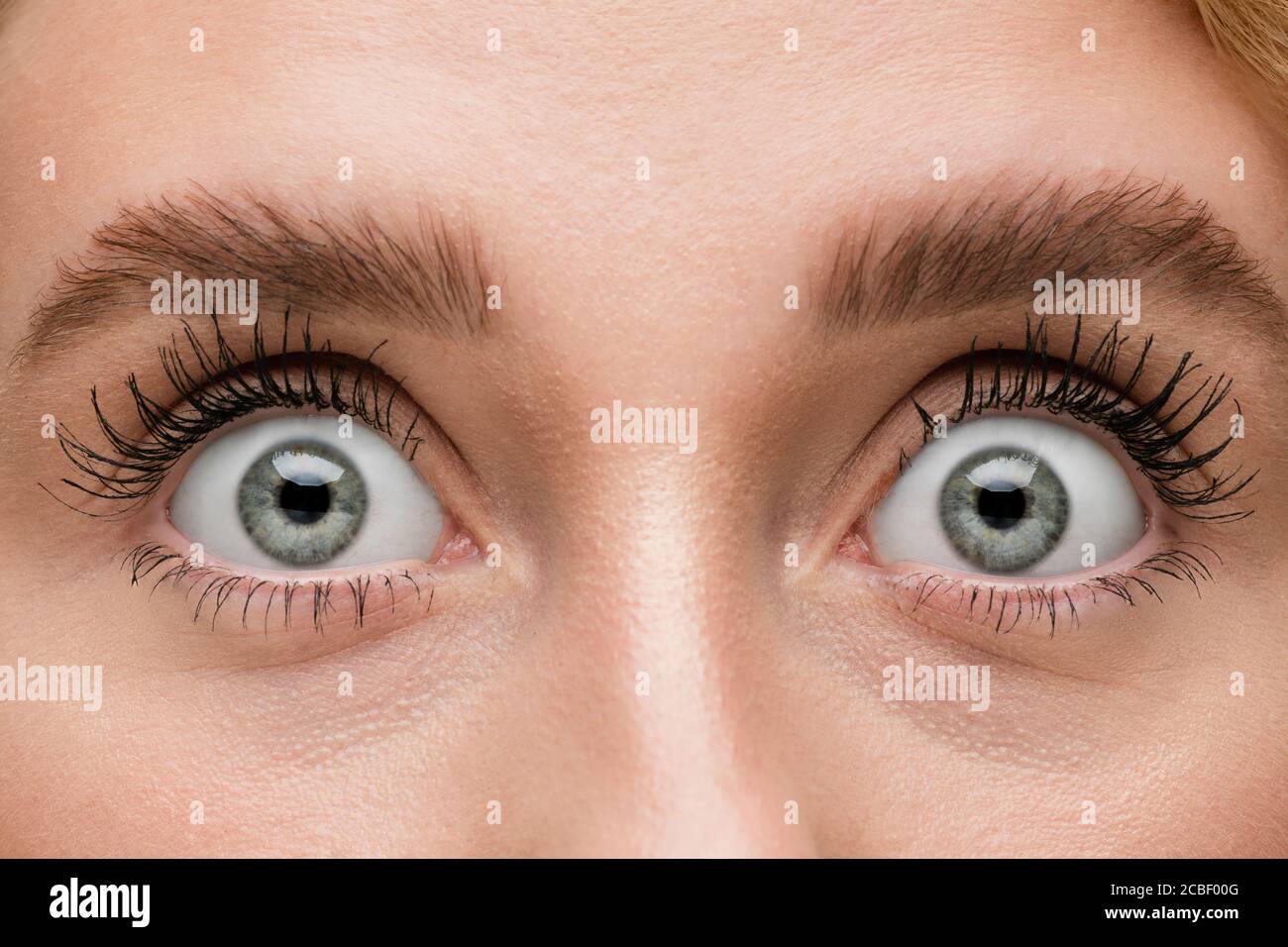 Shocked. Close up of face of beautiful caucasian young woman, focus on ...