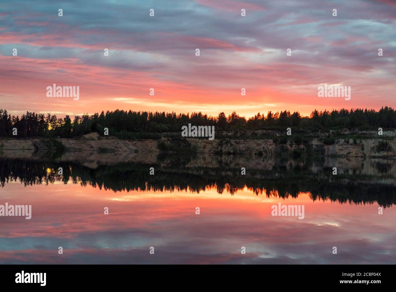 Mirror image of the sunset on the lake in spring Stock Photo - Alamy
