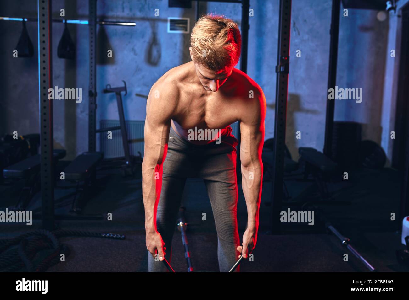 Power athletic male bodybuilder champion doing exercises with heavy ...