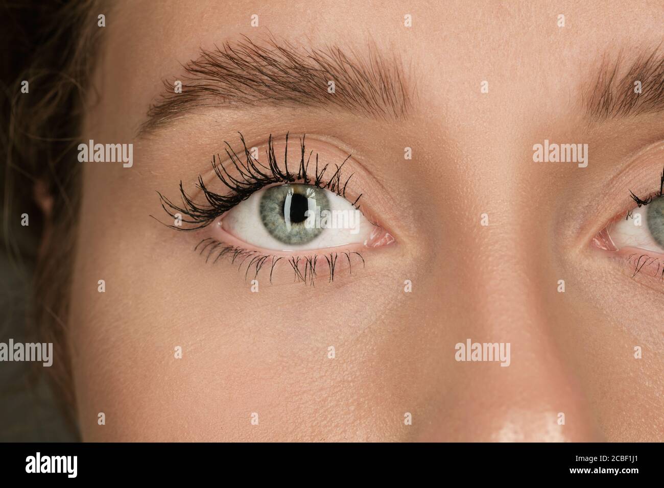 Calm. Close up of face of beautiful caucasian young woman, focus on ...