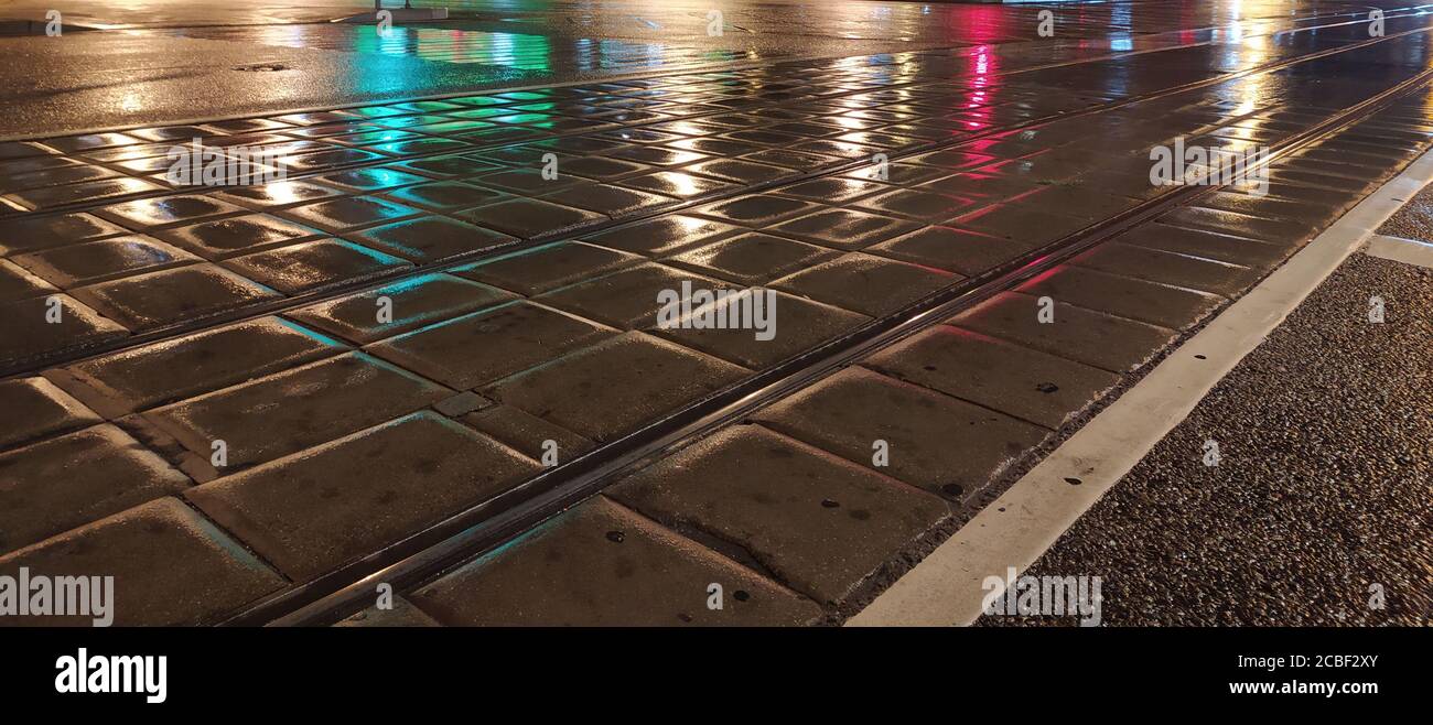 pavement wet from the rain with reflective lights in the evening Stock ...
