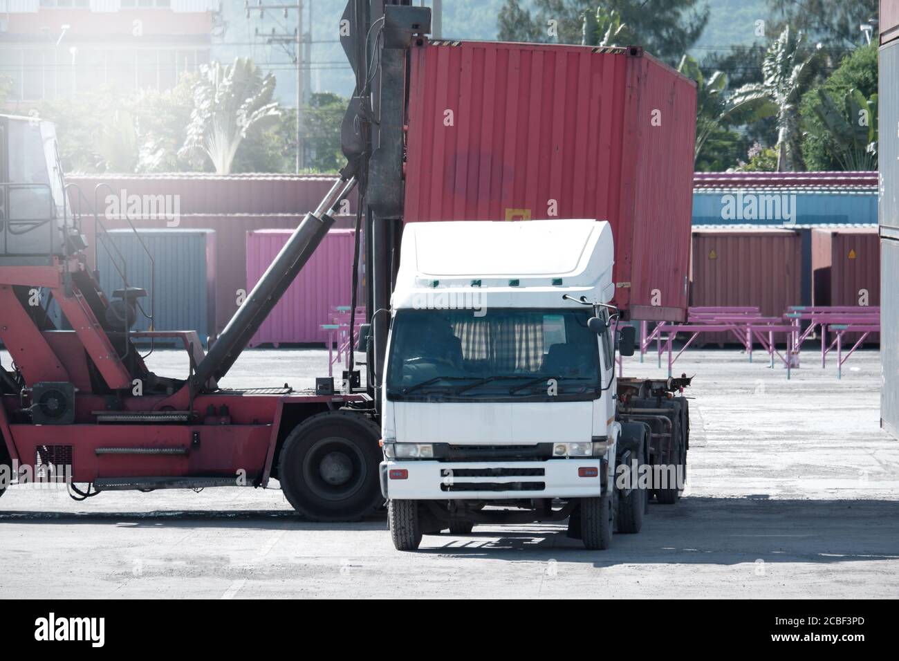 Trucks come to pick up the containers in the port Stock Photo - Alamy