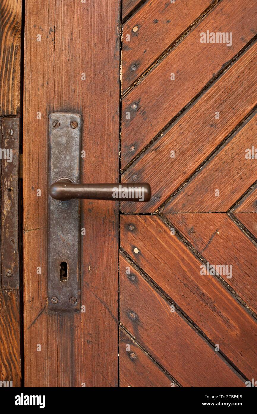 Wooden door with rustic lock and handle Stock Photo - Alamy