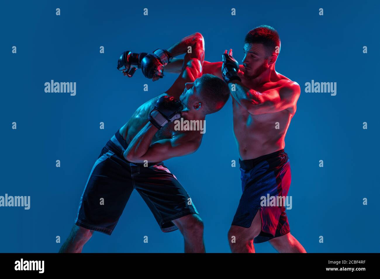 Tensioned. MMA. Two professional fighters punching or boxing isolated ...