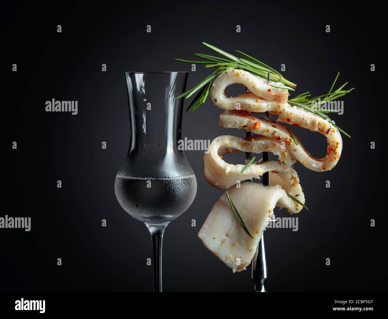 Frozen glass with cold vodka and a slice of spicy salted lard. Lard ...
