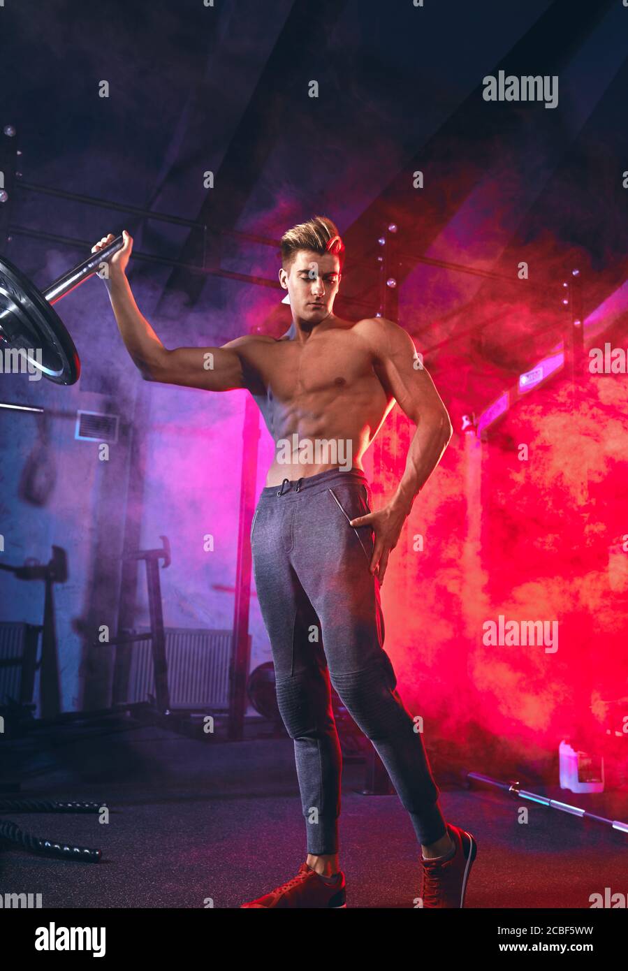 Power athletic male bodybuilder champion doing exercises with heavy ...