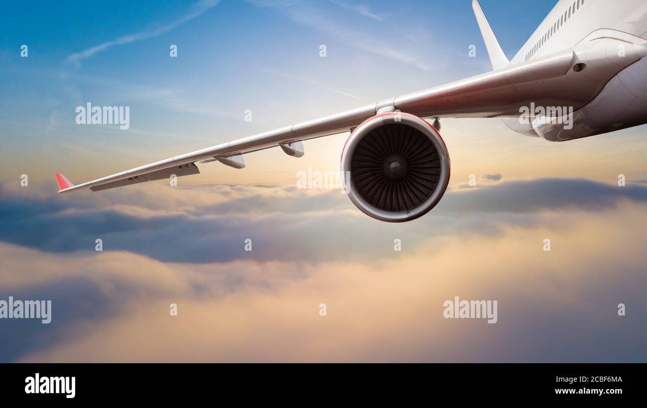 Detail of commercial jet airplane flying above clouds. Modern and ...