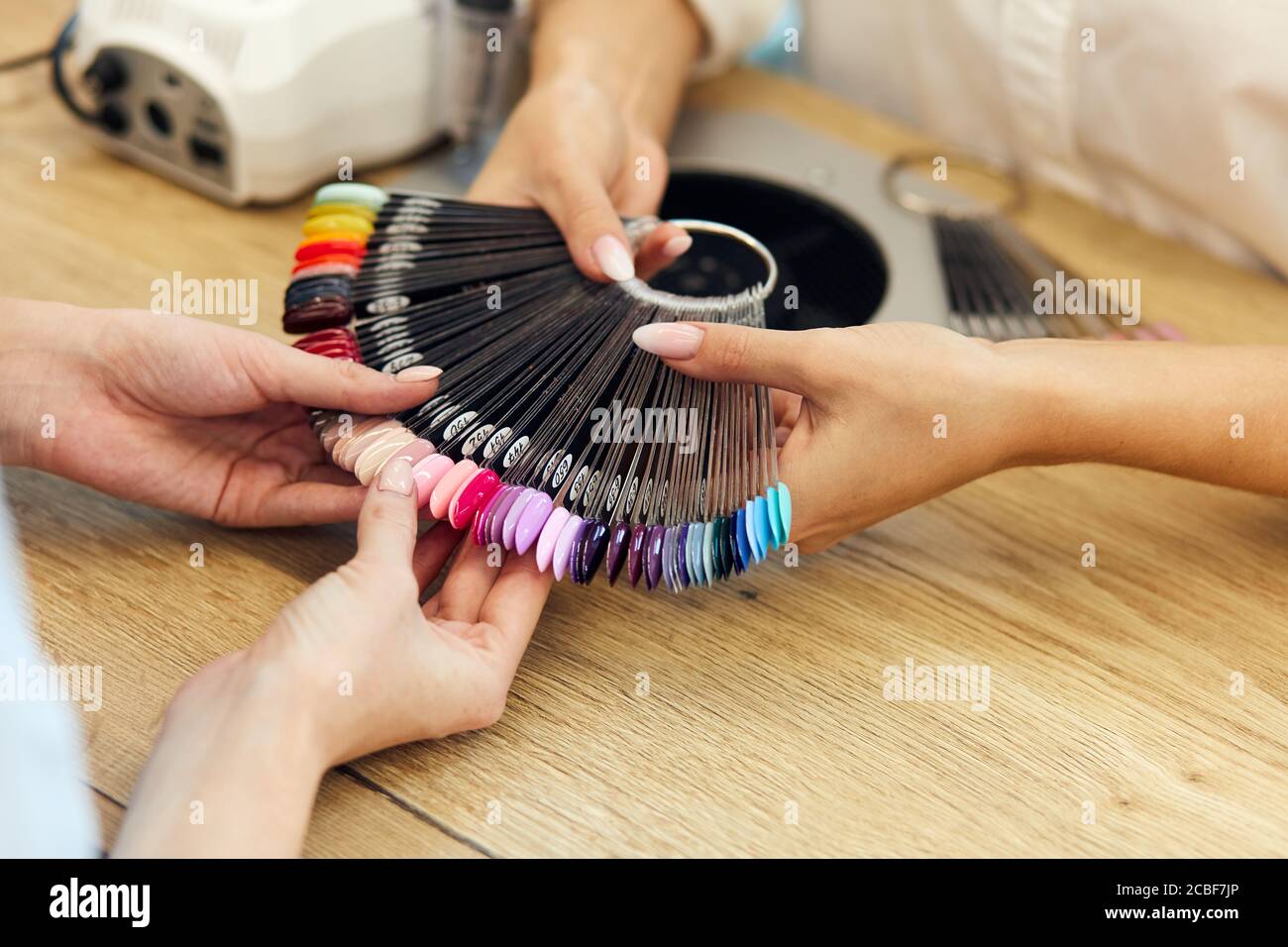 Master and model in beauty salon. Make choice of nails design Stock ...