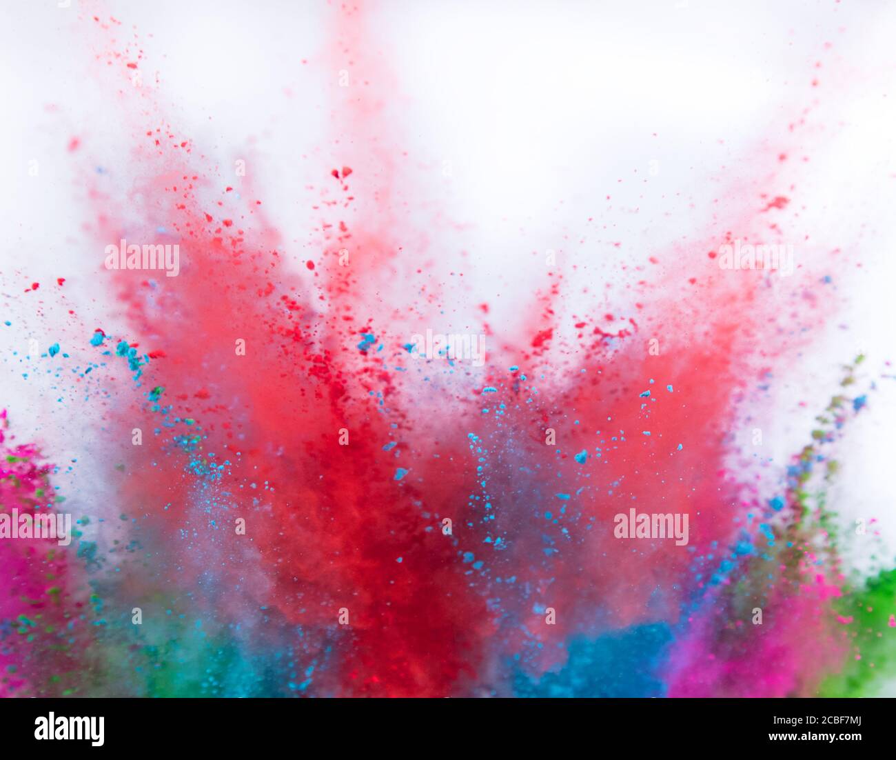 Multi colored powder explosion isolated on white background. Freeze ...