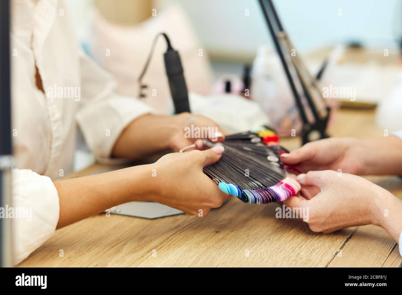 Master and model in beauty salon. Make choice of nails design Stock ...