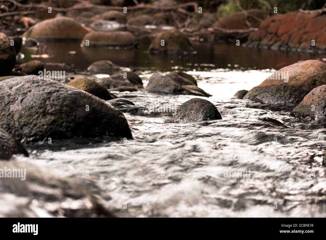 Water flowing through river on the country side Stock Photo - Alamy