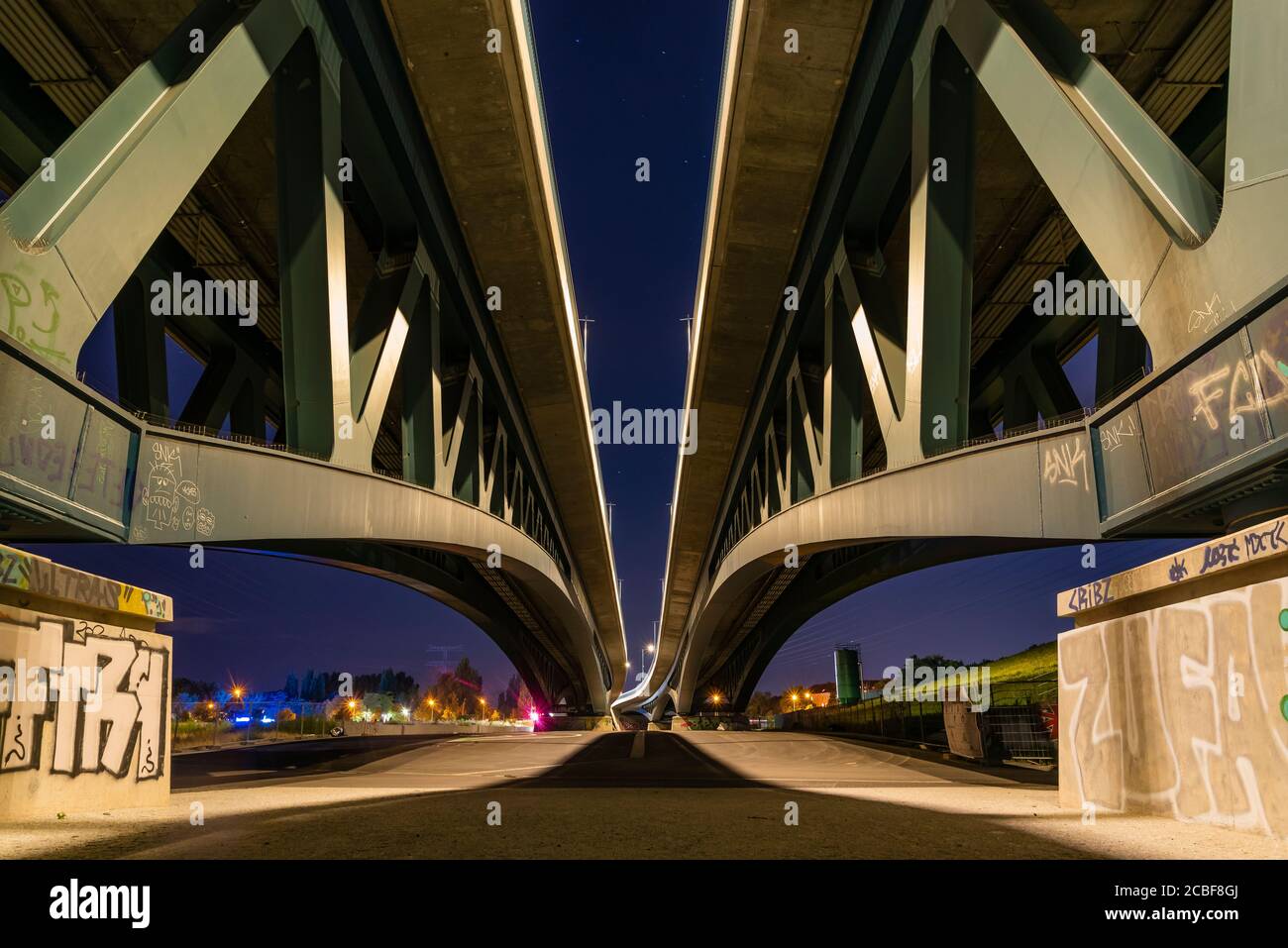 Under a large bridge at night, a massive bridge construction at night ...