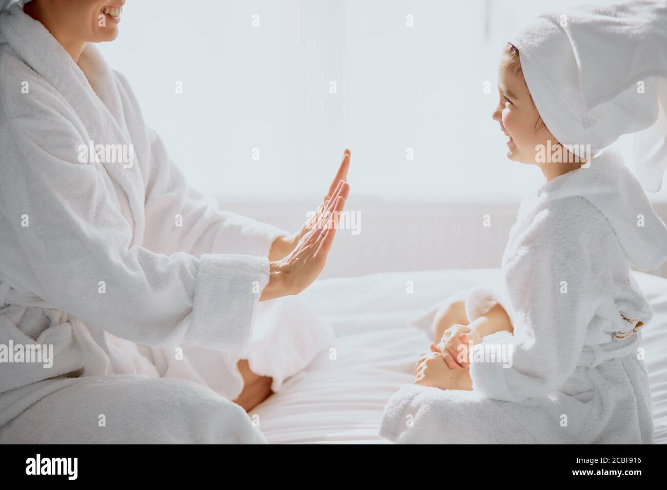 attractive beautiful female clap hands with each other, wearing ...