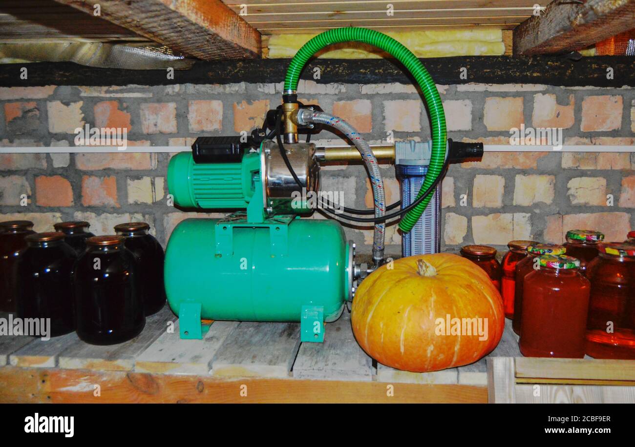 Electric compressor with motor on a shelf in the basement of the house ...