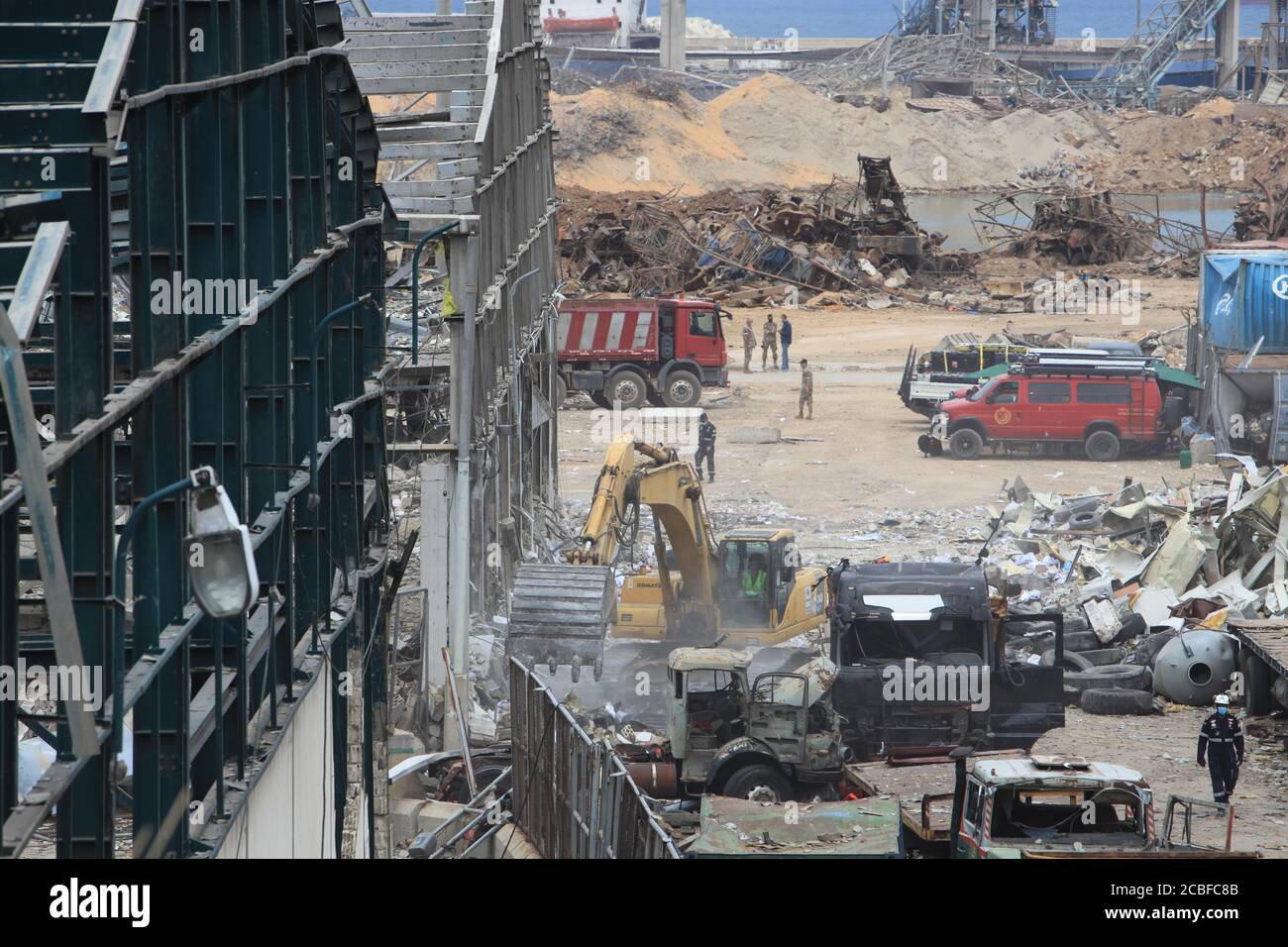 Beirut. 13th Aug, 2020. An excavator works outside a destroyed ...