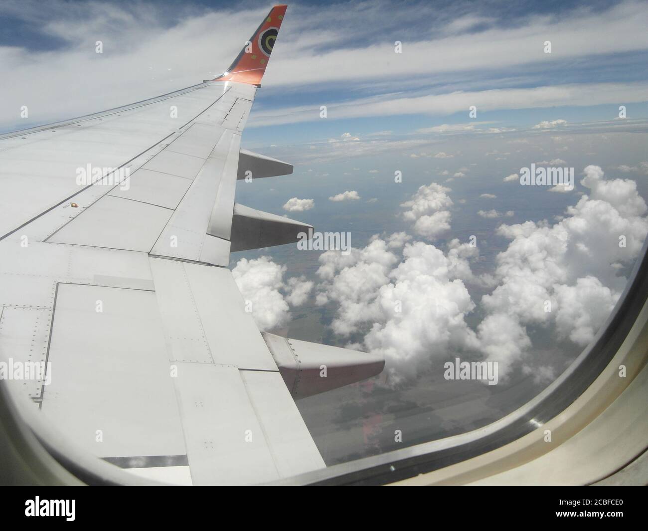 Overwing plane window view Stock Photo - Alamy