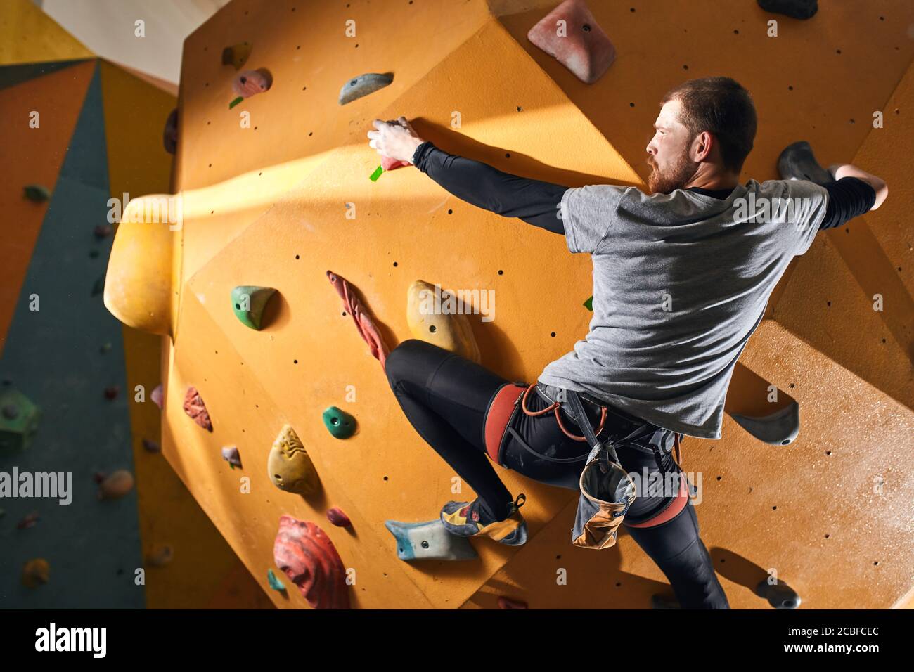 Back view of motivated muscular boulderer with physical disability ...