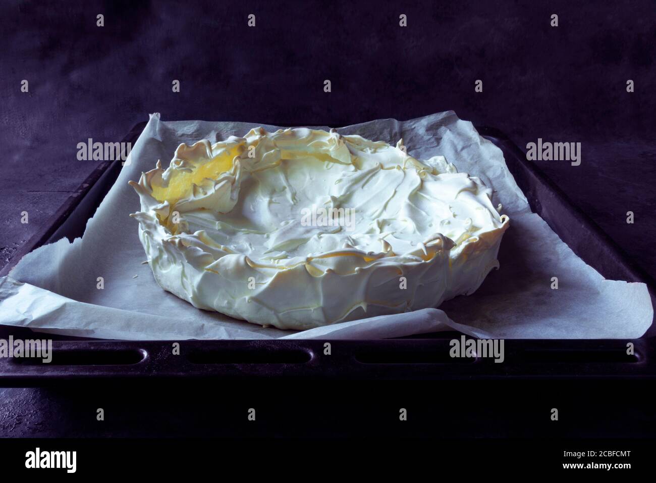 Homemade white meringue basis for cake Anna Pavlova on paper and black ...