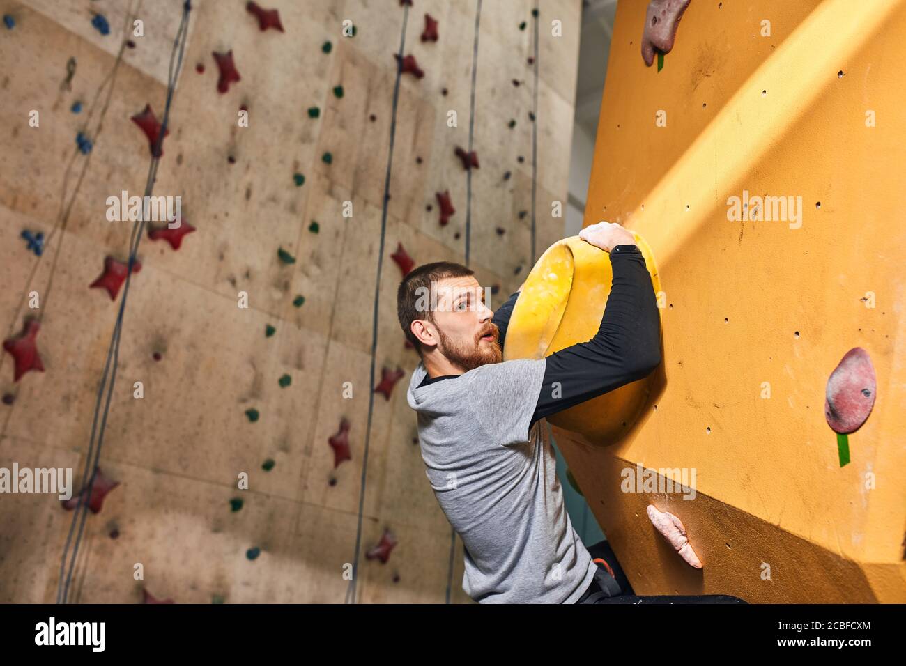 Half-body shot of strong muscular rock-climber with physical disability ...
