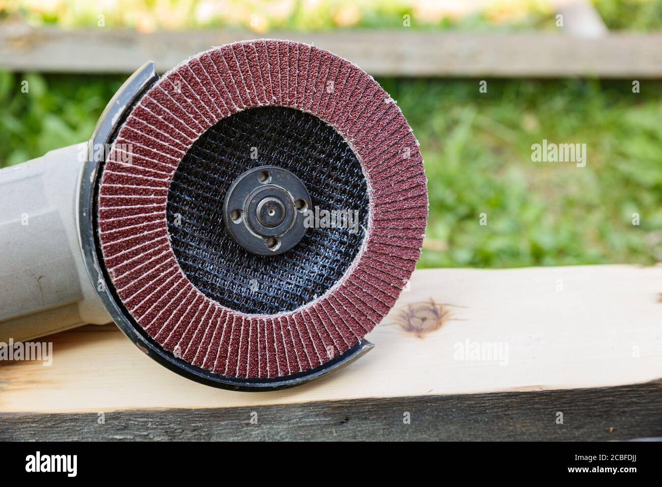 The electric wood sander lies on a smooth board Stock Photo - Alamy