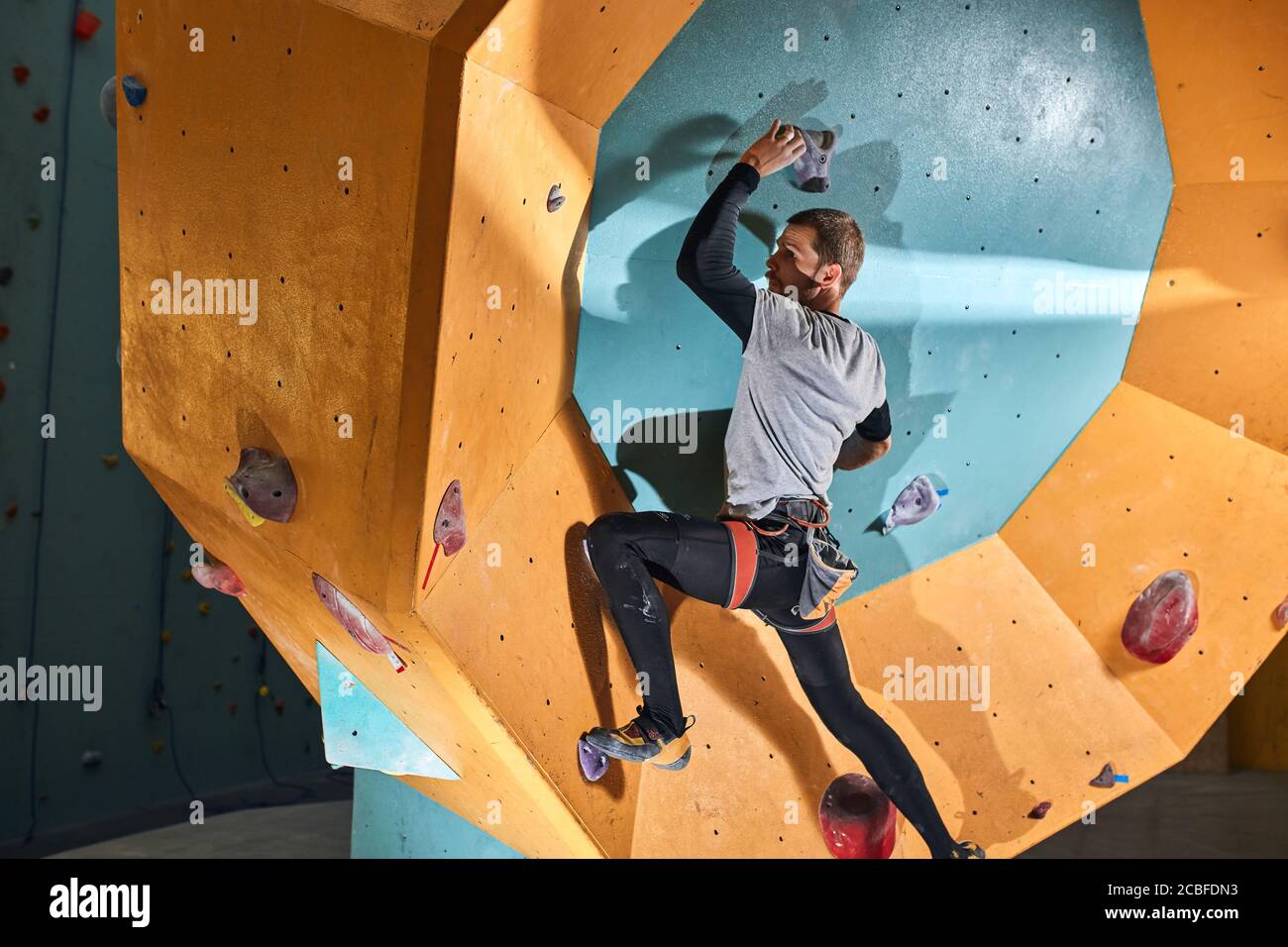 Strong handsome climber takes part in annual indoors bouldering ...