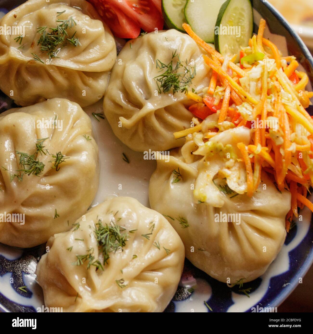 Traditional Oriental manta dish with vegetable salad on a plate Stock ...