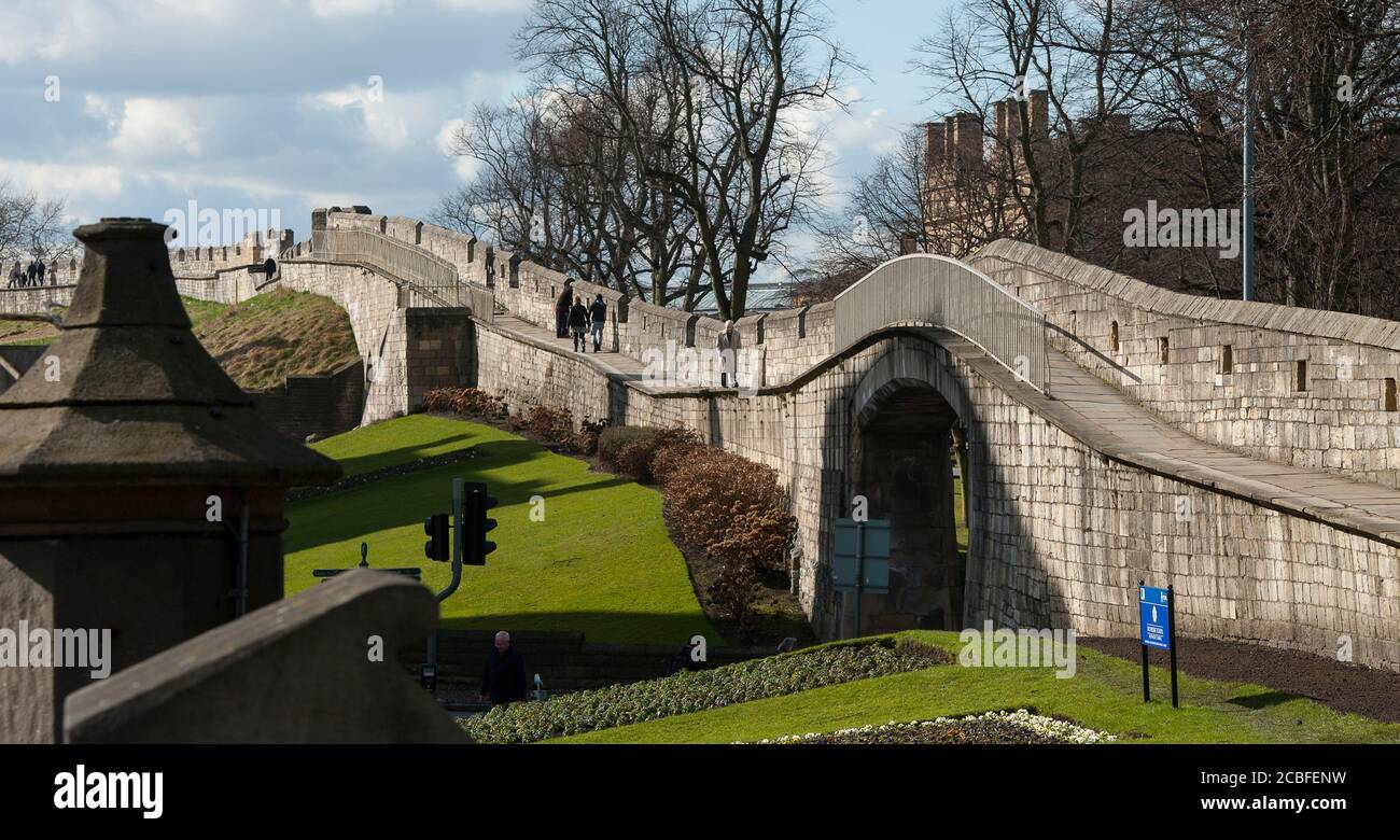 People walking along the historic York City Walls, York, England Stock ...