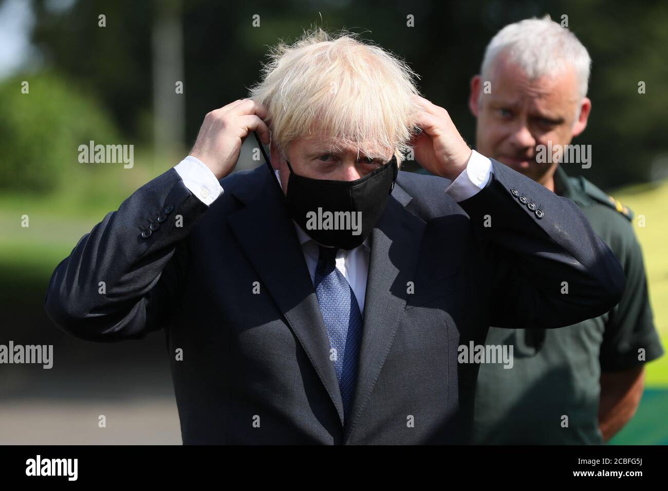 Prime Minister Boris Johnson puts on a mask at the Northern Ireland ...